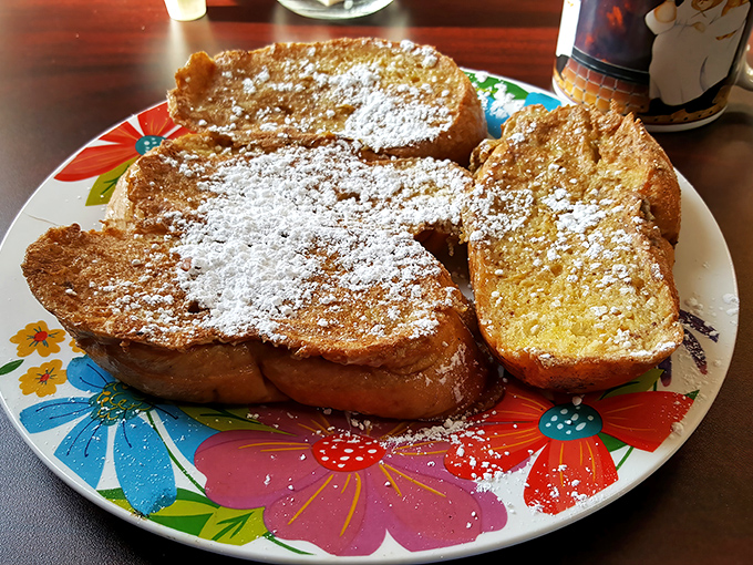 Behold the French toast that launched a thousand breakfast pilgrimages – powdered sugar falling like delicious snow.