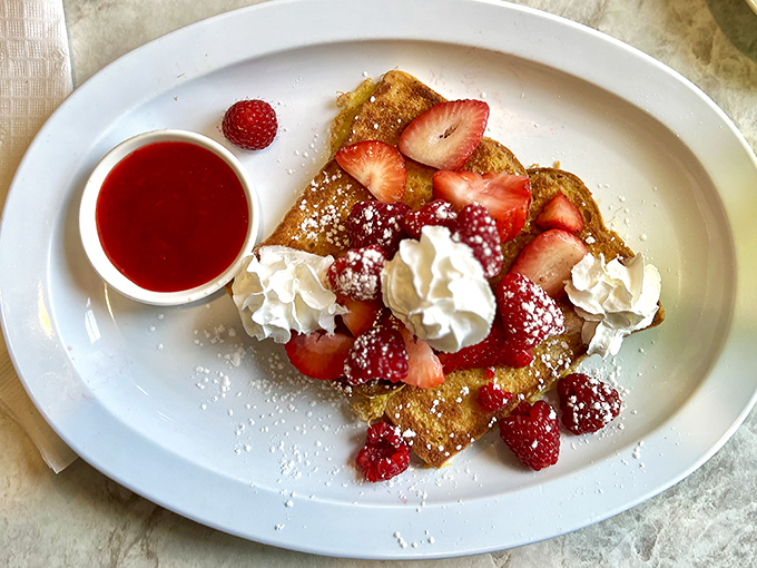 French toast that doesn't just break your fast but makes your morning—crowned with fresh strawberries and whipped cream clouds.
