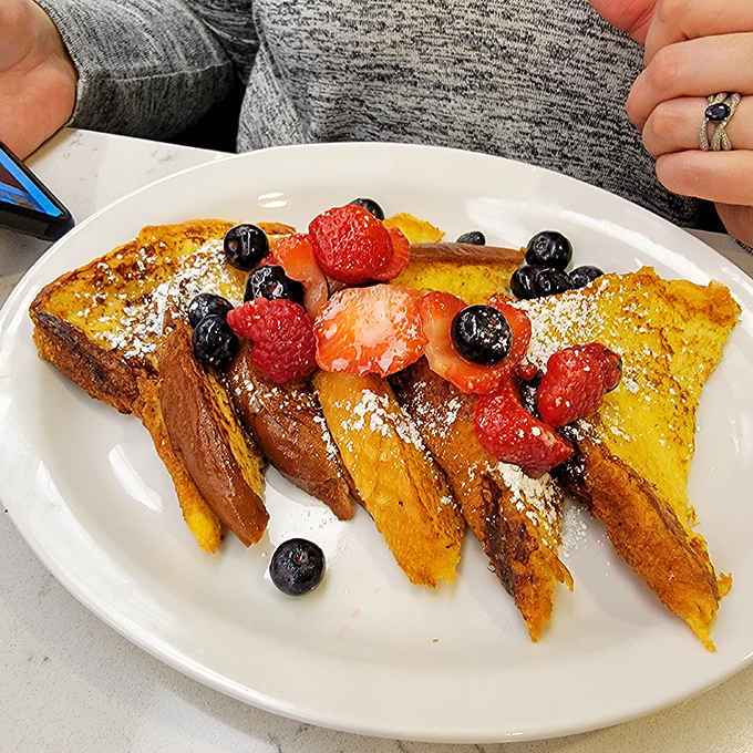 This berry-topped French toast isn't just breakfast—it's edible sunshine that transforms ordinary bread into a custard-centered miracle worth the drive.