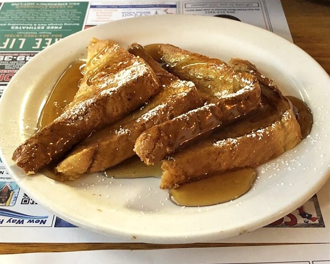 French toast that's achieved celebrity status in its own right—golden, crispy edges giving way to a custardy center that's worth setting the alarm for.