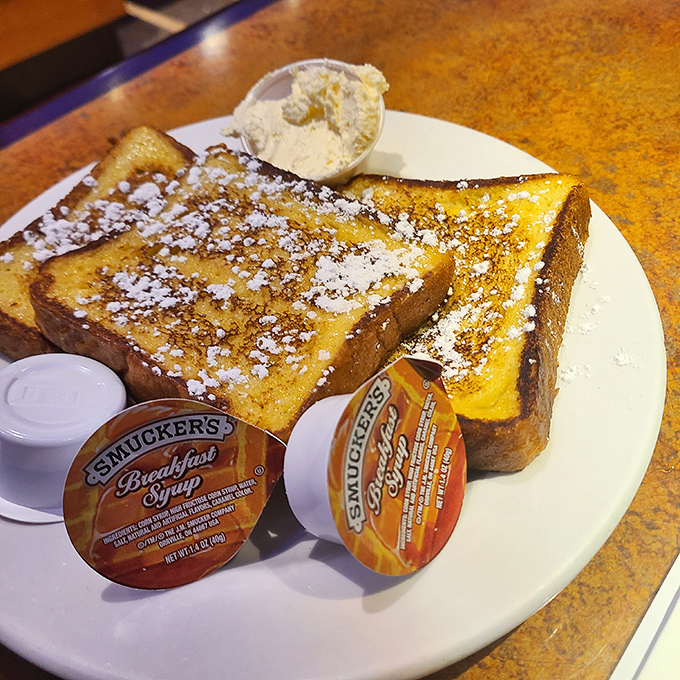 Golden-brown French toast dusted with powdered sugar – the breakfast equivalent of finding out your favorite band is playing in your backyard.