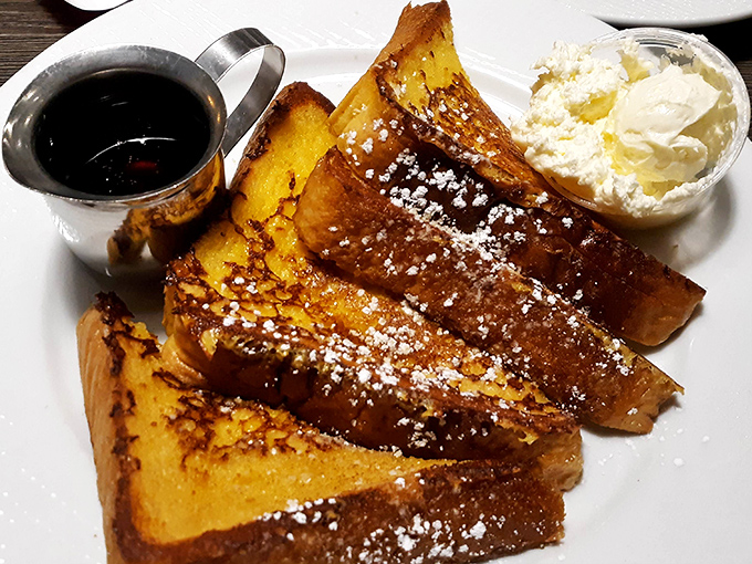 Golden-brown French toast that's achieved celebrity status in Chicago—crisp edges, custardy center, and that perfect dusting of powdered sugar.