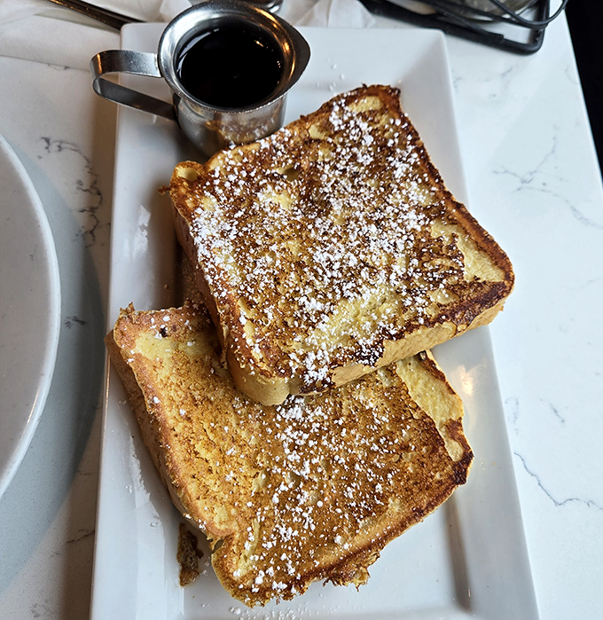 Golden-brown French toast dusted with powdered sugar—proof that the simplest pleasures are often the most satisfying.