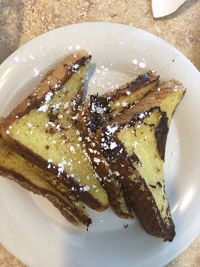 This French toast doesn't just steal the show—it runs away with the entire theater. Golden, custardy perfection dusted with powdered sugar.