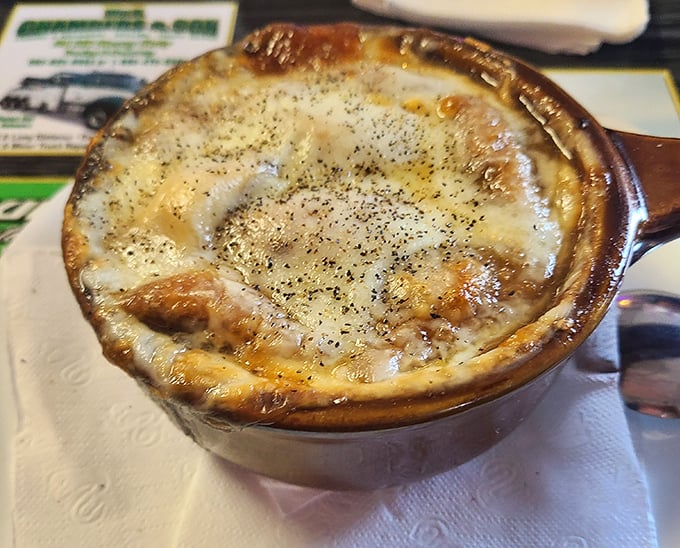This isn't just French onion soup—it's a bubbling cauldron of melted cheese paradise that would make even the most sophisticated Parisian weep with joy.