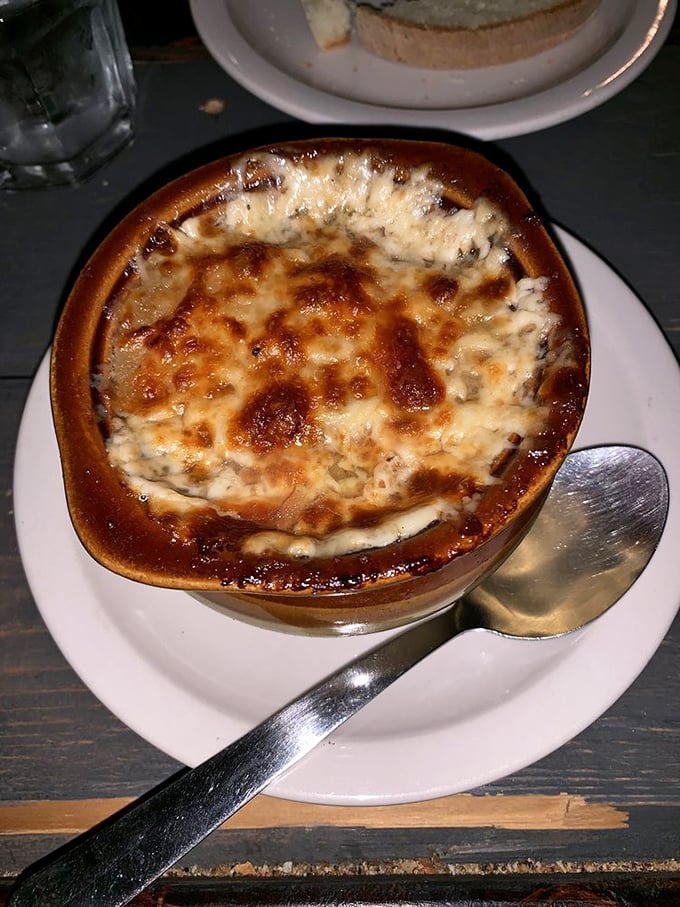 Behold the French onion soup in all its glory—a bubbling cauldron of cheese-capped perfection that makes you want to break into song.