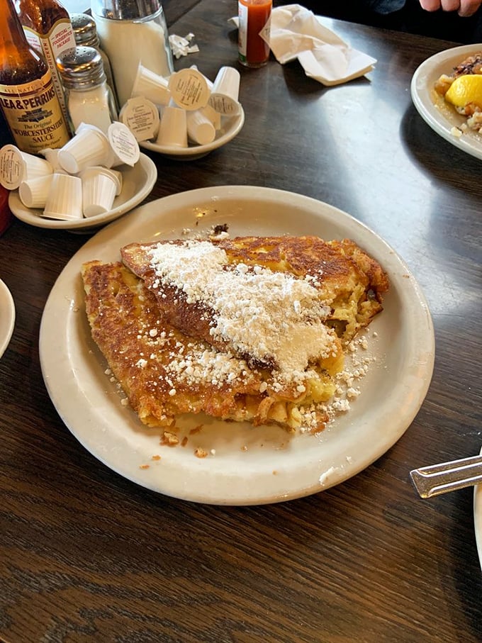 Golden French toast dusted with powdered sugar sits like breakfast royalty. The crispy edges practically whisper "forget your diet" with each bite.
