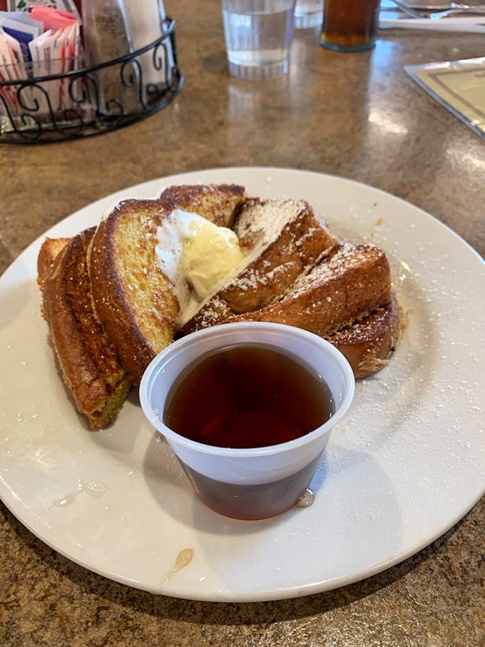 Golden-brown French toast dusted with powdered sugar – the breakfast equivalent of finding an extra $20 in your pocket. 