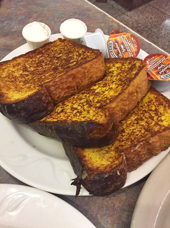 The French toast at Minella's doesn't just arrive—it makes an entrance, thick-cut and golden-brown with a custard-like interior that dreams are made of.
