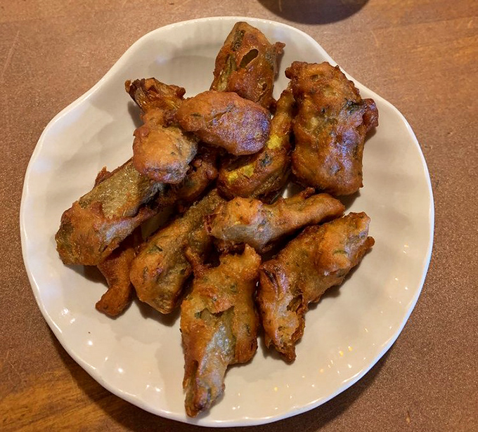Golden-brown perfection on a plate. These deep-fried artichoke hearts are what food dreams are made of—crispy exterior, tender interior, pure California bliss.