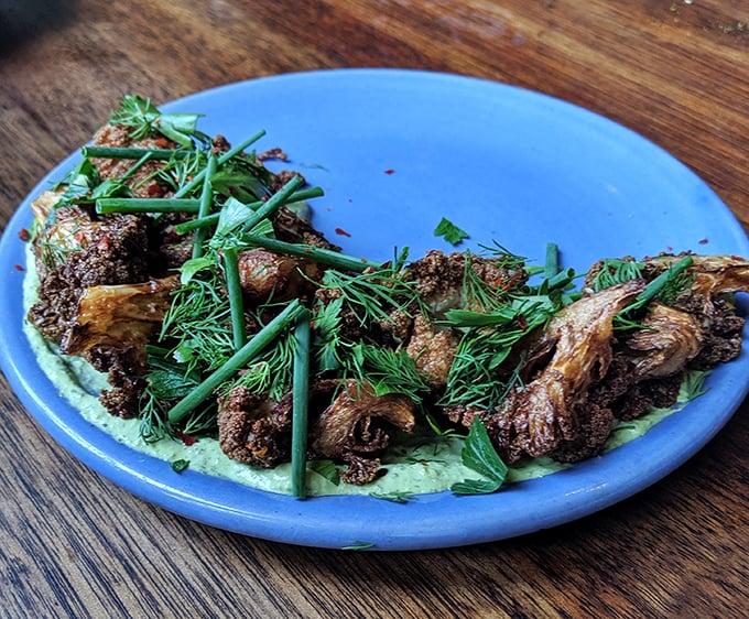 This isn't your grandmother's cauliflower. Crispy, aromatic, and nestled on creamy tahini—it's the vegetable that launched a thousand cravings.