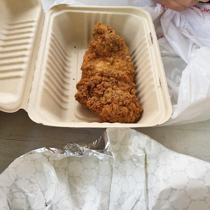 Golden-brown perfection in a takeout container. This fried chicken doesn't need fancy plating – its crackling crust speaks volumes about what awaits inside.