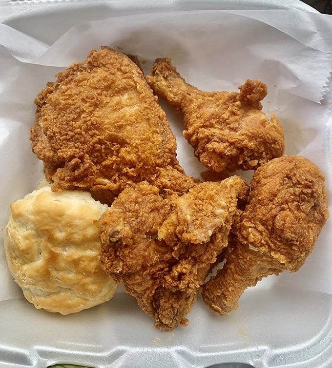 Golden-fried chicken that crackles with each bite, paired with a biscuit so fluffy it practically floats off the plate.