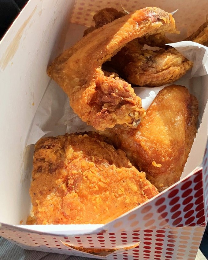 Golden-brown perfection in a box – this fried chicken doesn't need fancy plating when it's wearing a crust that crackles like a symphony.