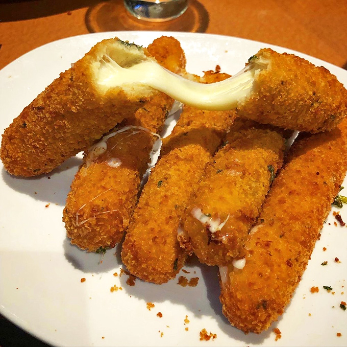 The stars of the show – golden-crusted mozzarella sticks with that Instagram-worthy cheese pull that makes your mouth water before the first bite.