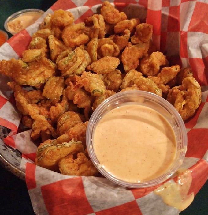 Golden-battered pickle chips that shatter with each bite. The dipping sauce isn't optional—it's the perfect tangy companion to this crispy delight.