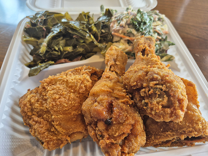 Golden-brown perfection meets Southern tradition on this plate. The collard greens and coleslaw aren't just sides—they're supporting actors deserving their own Oscar.
