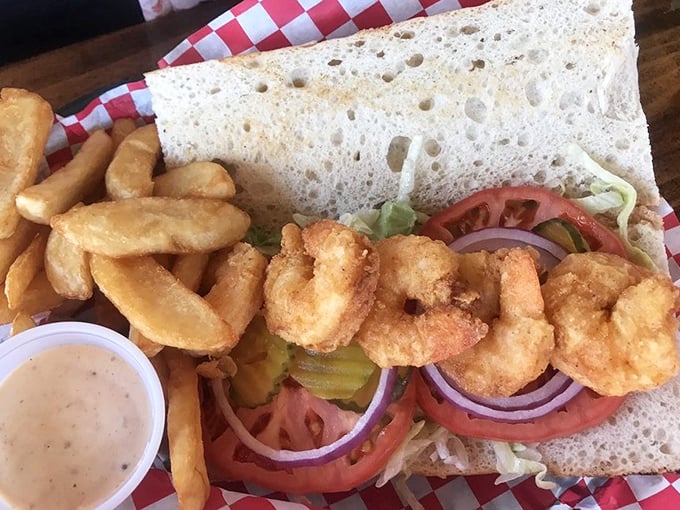 This isn't just a shrimp po-boy; it's a masterclass in sandwich architecture. Crispy golden shrimp nestled in fresh veggies—a beautiful relationship on bread.