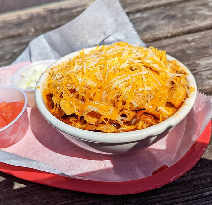 Behold the crown jewel: Billy's Frito pie, where corn chips swim beneath a golden avalanche of cheese, waiting to transport you to Texas heaven.