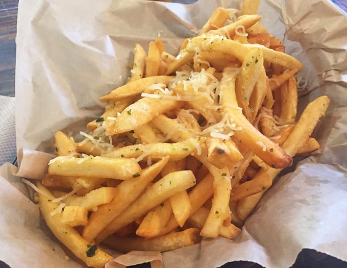 These aren't just fries; they're golden batons of joy topped with enough garlic and cheese to make your cardiologist nervous.