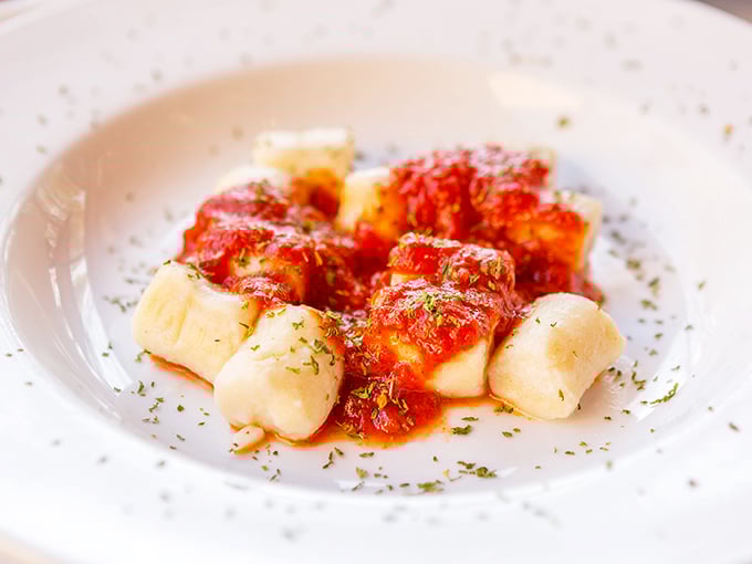 Pillowy gnocchi swimming in vibrant marinara sauce—this isn't just pasta, it's a cloud-like potato revelation that would make any Italian grandmother weep with joy.