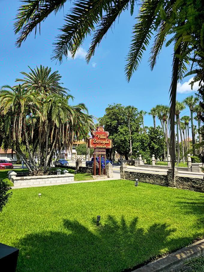 Even the grounds maintain the exotic illusion—lush Florida greenery surrounding that iconic red sign, as if Granada and St. Augustine had a beautiful architectural baby.