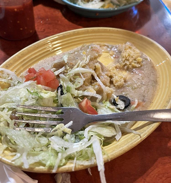 This green corn tamale doesn't just sit on the plate—it beckons with its comforting embrace of masa and fresh ingredients. Comfort food that speaks Spanish.
