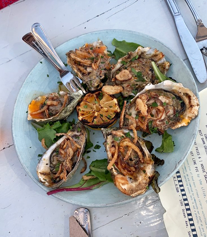 These grilled oysters aren't just appetizers—they're life-changing experiences with caramelized miso butter that will haunt your dreams in the best way possible.