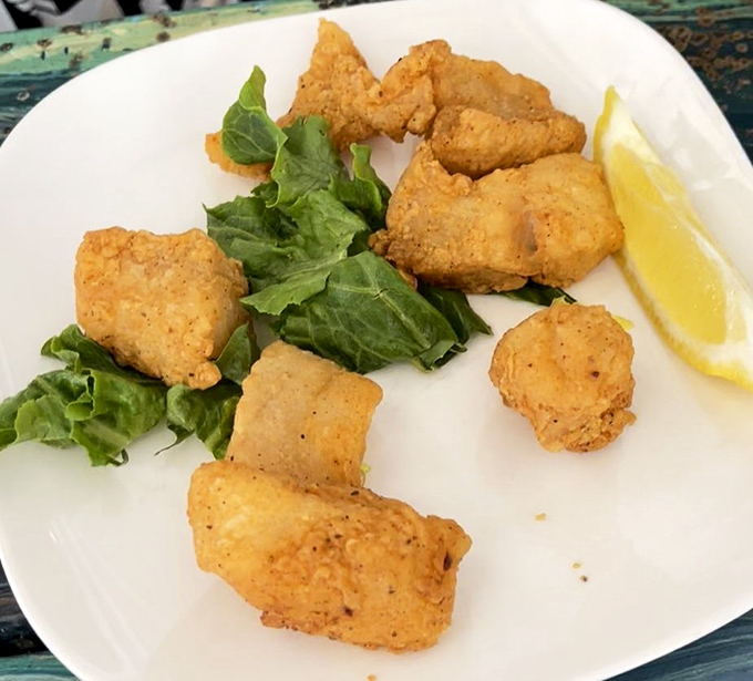 Golden-fried grouper nuggets that make you question every fish stick you've ever eaten. That lemon wedge isn't decoration – it's the perfect dance partner.