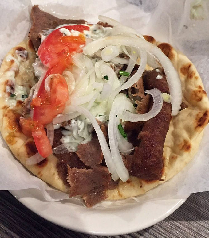 Behold the gyro in all its glory – tender meat, fresh vegetables, and tzatziki creating pure handheld happiness.