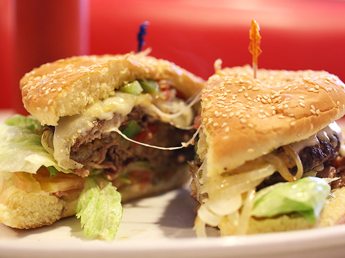 Behold the humble hamburger elevated to art form—where melted cheese cascades over perfectly seared beef in a dance as old as American cuisine itself.