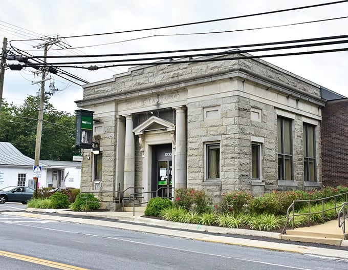 This stately stone bank building stands as Hampstead's architectural crown jewel – when banks were built to inspire confidence, not just house ATMs.