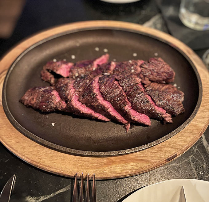 Perfectly seared hanger steak, sliced to showcase that glorious medium-rare interior. Meat this good doesn't need fancy tricks—just respect and proper technique.
