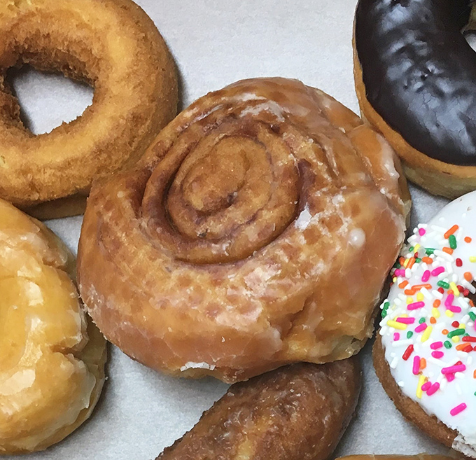 The cinnamon roll—humanity's greatest achievement in spiral engineering. This glistening specimen from Schneider's makes a compelling case for breakfast dessert.