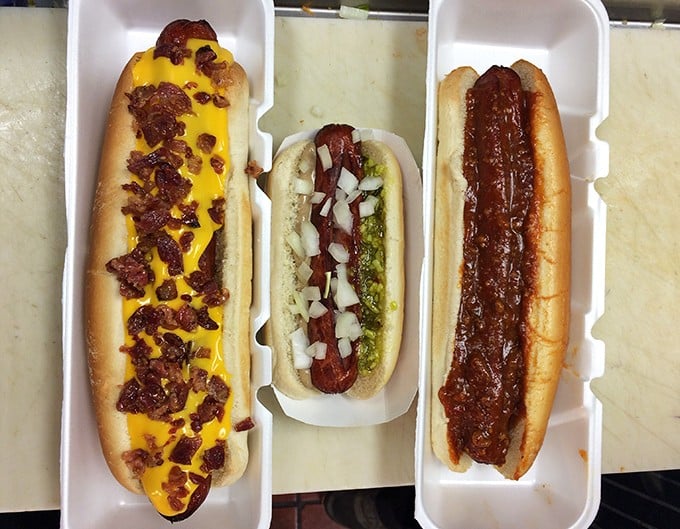 Hot dog heaven exists, and it comes in three varieties: cheese-bacon bliss, classic Chicago-style, and smothered in homestyle chili that'll haunt your dreams.