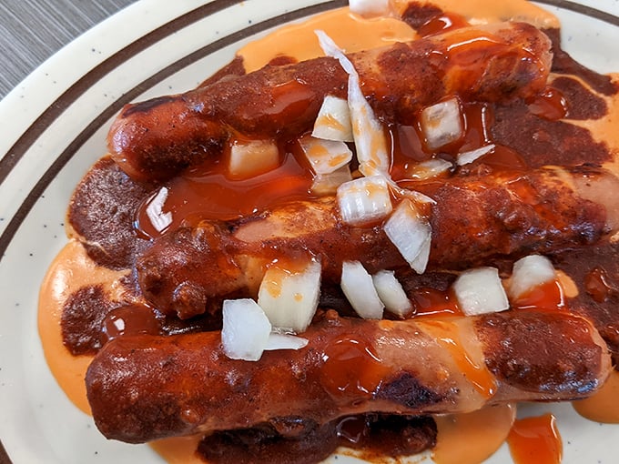 These aren't just hot dogs—they're edible works of art. The chili cascades over perfectly grilled franks while diced onions add that essential crunch.