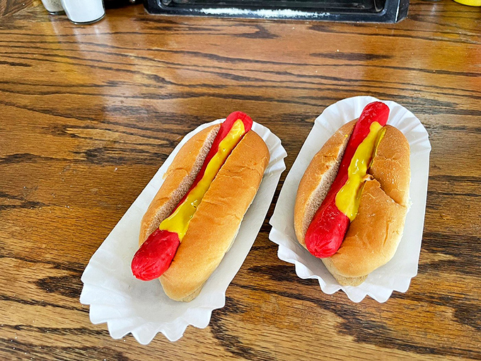 Bright red dogs nestled in soft buns with a squiggle of mustard—proof that sometimes the simplest pleasures are the most satisfying.
