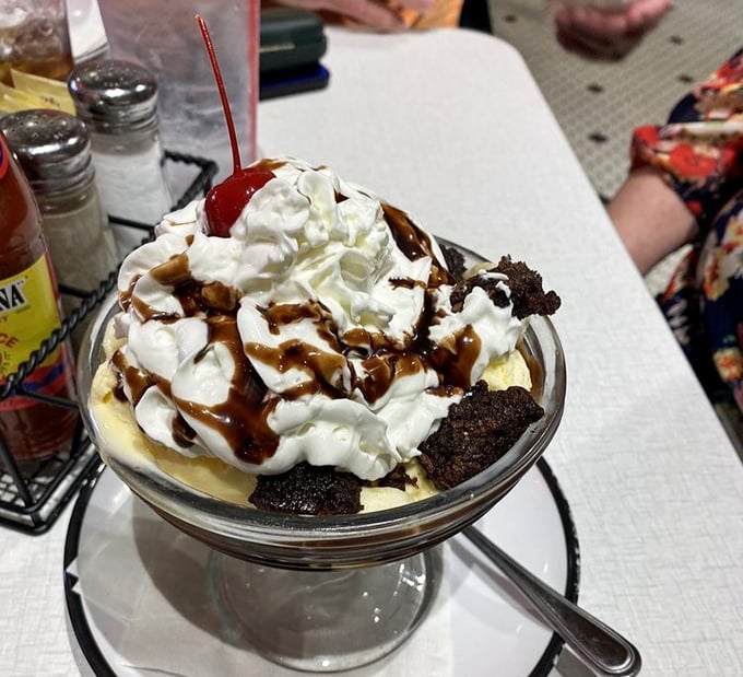 This towering masterpiece proves that sometimes more really is more, especially with hot fudge involved.