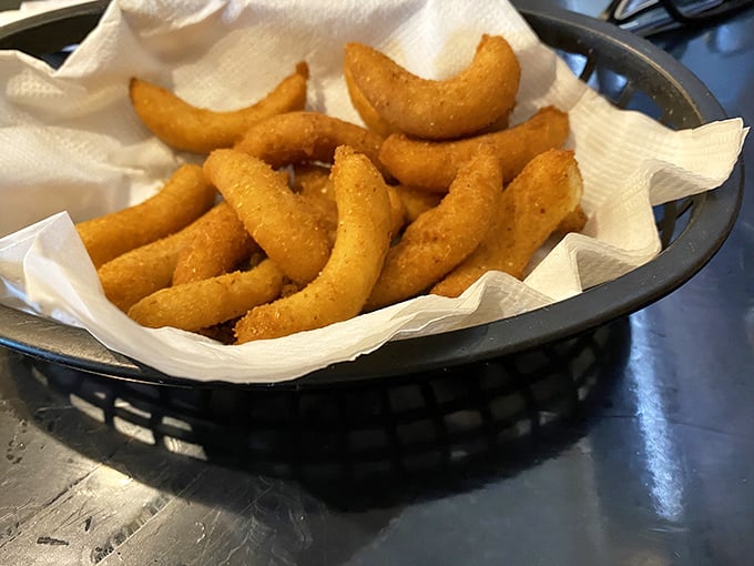 Golden-brown hush puppies that crackle with each bite – these aren't just side dishes, they're the main event's opening act.