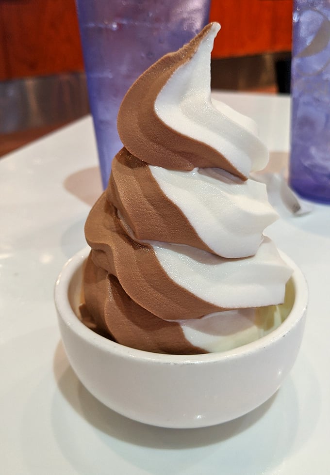 Behold the crown jewel: a perfect chocolate-vanilla twist that spirals toward the heavens like a dairy-based Tower of Babel.