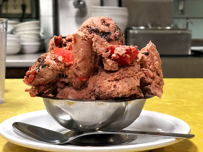 Not all heroes wear capes – some wield ice cream scoops. This chocolate creation with chunks of cherry is practically wearing a superhero cape.