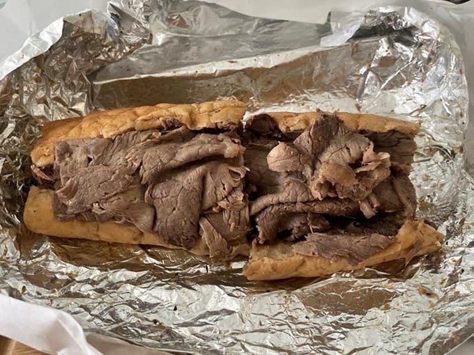 Behold the Italian beef in all its glory—thinly sliced, perfectly seasoned, and nestled in bread that somehow remains structurally sound despite its juicy baptism.