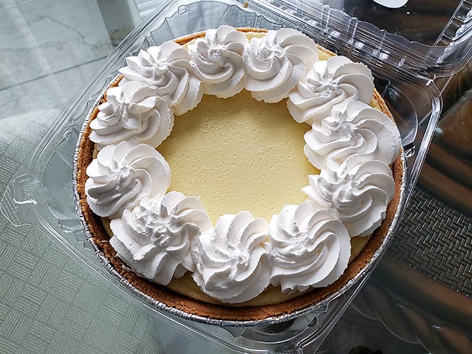 Key lime pie perfection: a sunshine-yellow filling crowned with whipped cream rosettes. This isn't dessert—it's Florida's edible ambassador.
