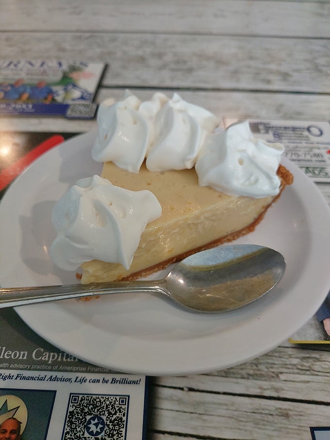 The key lime pie that launched a thousand road trips. That pale yellow filling is the real deal—no neon green imposters allowed here.