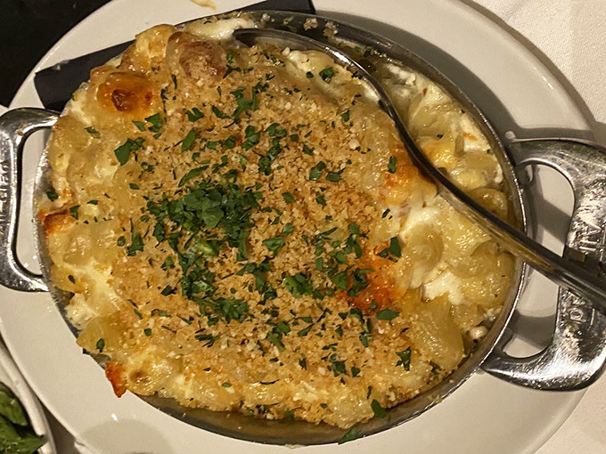 The legendary lobster mac and cheese arrives bubbling with promise. Like a cheesy hot tub where lobster chunks throw the party of the year.