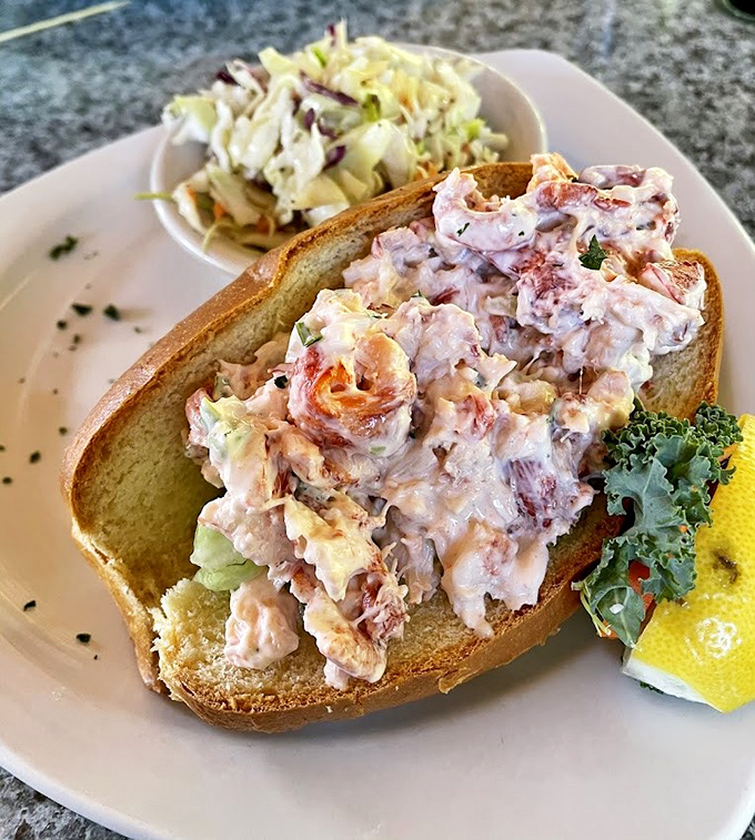 Behold the lobster roll that'll make you question every sandwich you've ever called "good" – pure perfection on bread.