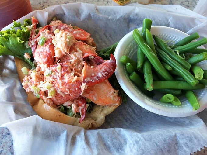 This isn't just a lobster roll—it's summer vacation on a toasted bun. The green beans are there to make you feel virtuous, but we know why you came.