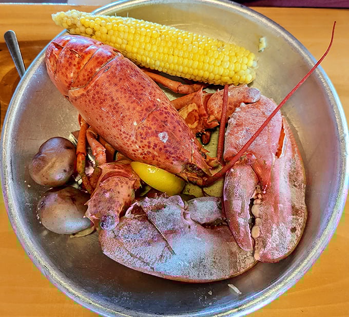 Maine lobster in all its crimson glory, served with corn and potatoes. This isn't just dinner—it's a crustacean celebration worthy of a bib.