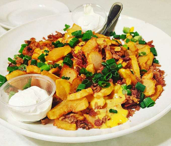 These loaded fries aren't just a side dish – they're a main event, with bacon, cheese, and green onions creating a potato paradise worth every delicious calorie.