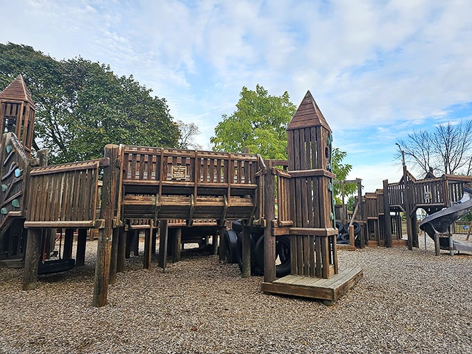 Kids rule the kingdom at Ludington Park's wooden playground fortress, where imagination runs wild and parents secretly wish they could join in.